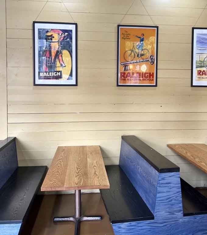 Booth seating with Raleigh-themed posters reminds you this isn't New York, but the pizza doesn't seem to care.