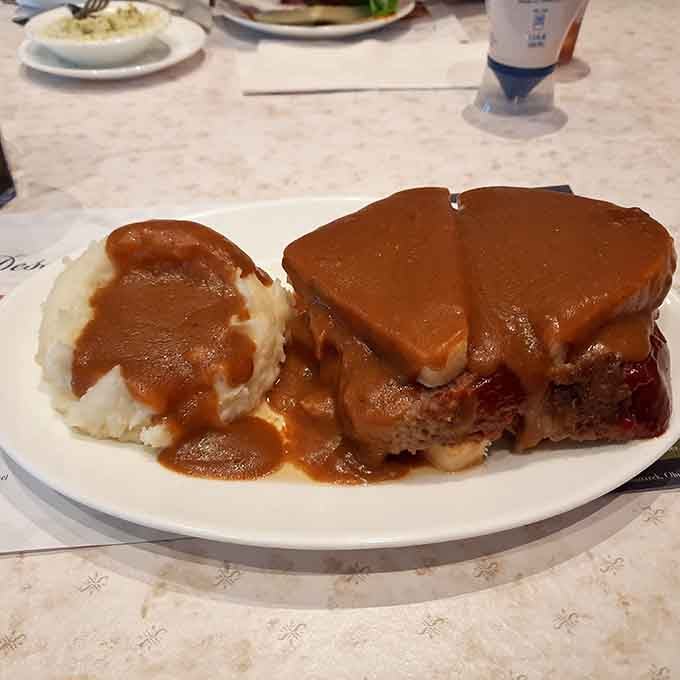 Meatloaf Manhattan drowning in gravy, because if you're going to do comfort food, commit to the bit.