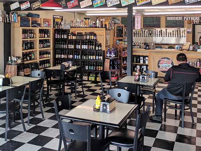 Black and white checkered floors and vintage signs create an atmosphere that's pure Americana at its finest.