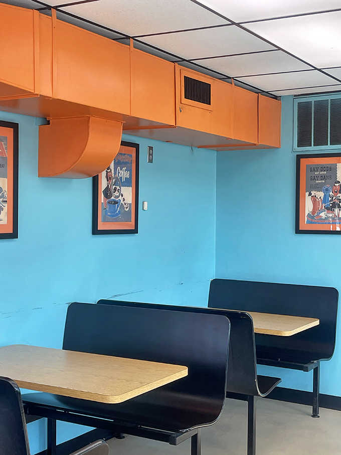 Bright booths and vintage vibes create the perfect setting for serious burger contemplation and casual conversation.