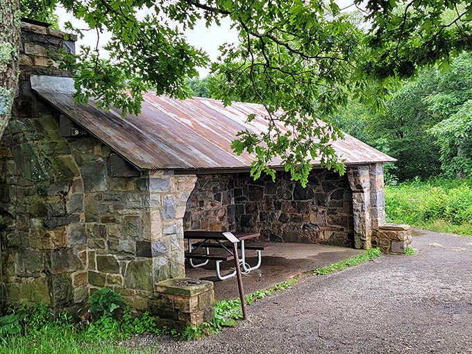 Stone shelter standing strong against decades of weather, offering picnic protection that's outlasted most modern relationships and several presidents.