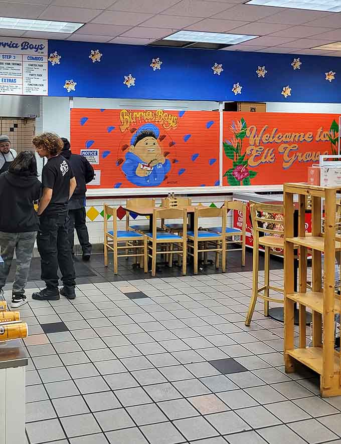 Simple wooden seating and colorful tile floors create a surprisingly cheerful atmosphere for your gas station birria feast.