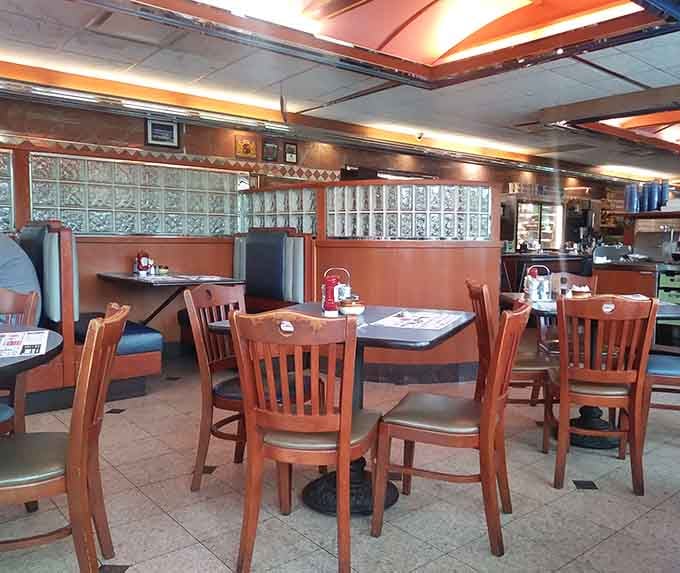 Spacious dining area with comfortable booths where families gather and friendships strengthen over shared meals and laughter.