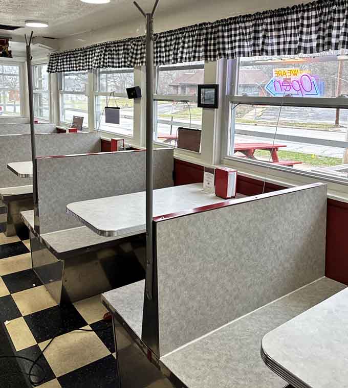 Classic booth seating with checkered curtains, offering the perfect spot to enjoy your burger in retro comfort.