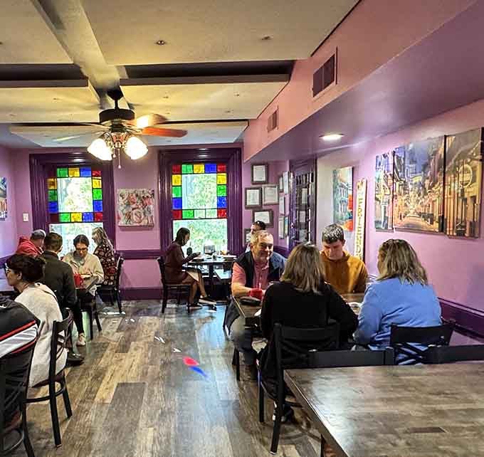 Happy diners enjoying their meals in a space where purple walls somehow make everything taste even better than expected.