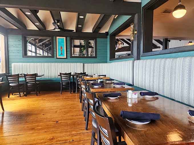 Booth seating with coastal colors that whisper "relax" louder than your spouse yelling about being late for dinner reservations.