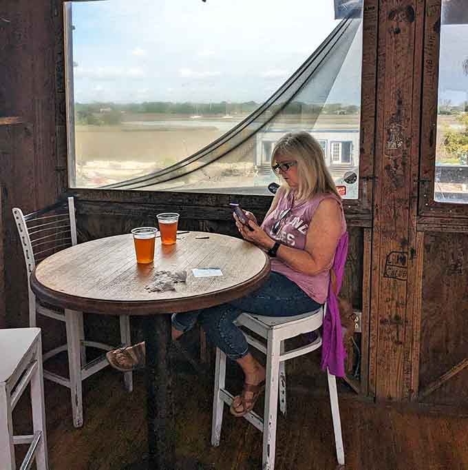 Sometimes the best dining companion is a cold drink, a marsh view, and the kind of solitude that lets you savor every bite.