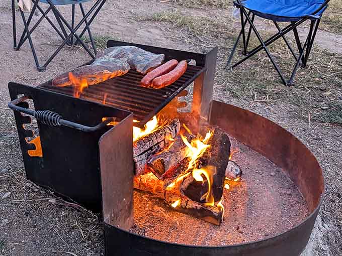 Campfire cooking with flames licking at sausages and fish proves the best meals often come from the simplest preparations outdoors.