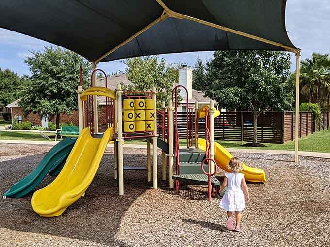 Bright playground equipment pops against the greenery, turning ordinary park time into an adventure kids actually remember.