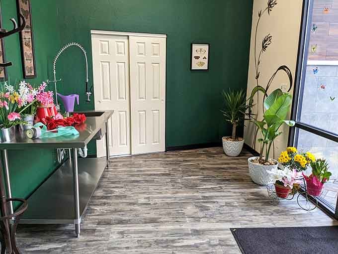 The entrance welcomes you with fresh flowers and emerald walls, setting expectations high before you've even ordered anything yet.