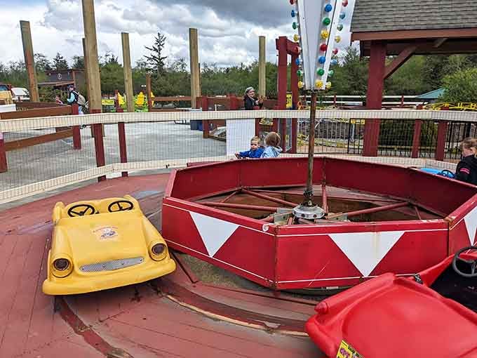 Colorful kiddie cars spin in circles, teaching the important life lesson that steering is surprisingly difficult.