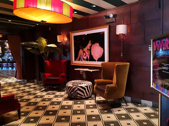 Velvet chairs and bold artwork create a lounge space that's fancier than your living room but somehow twice as welcoming.