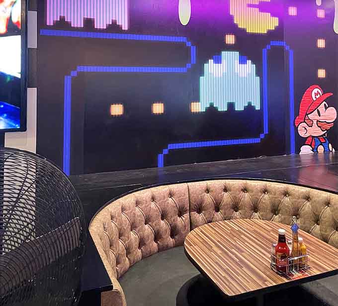 A cozy booth with pixel-perfect Pac-Man decor watching over your table like a nostalgic guardian angel of gaming.