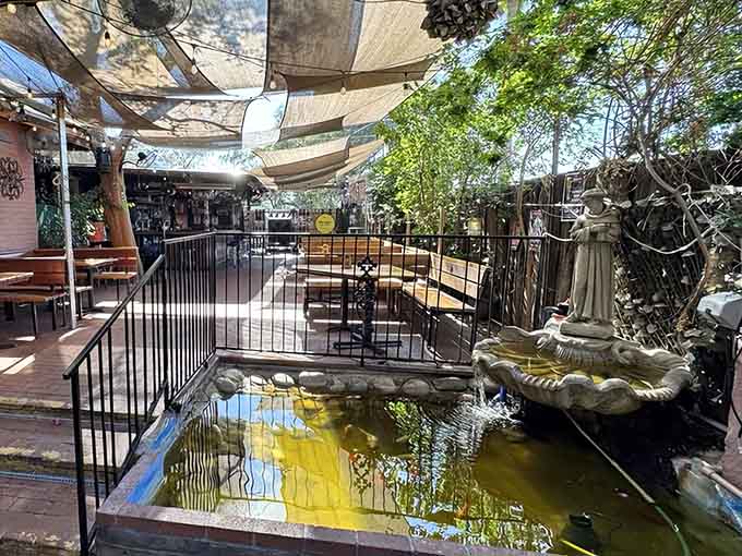 A tranquil pond with a fountain statue adds unexpected serenity to this already magical outdoor space.