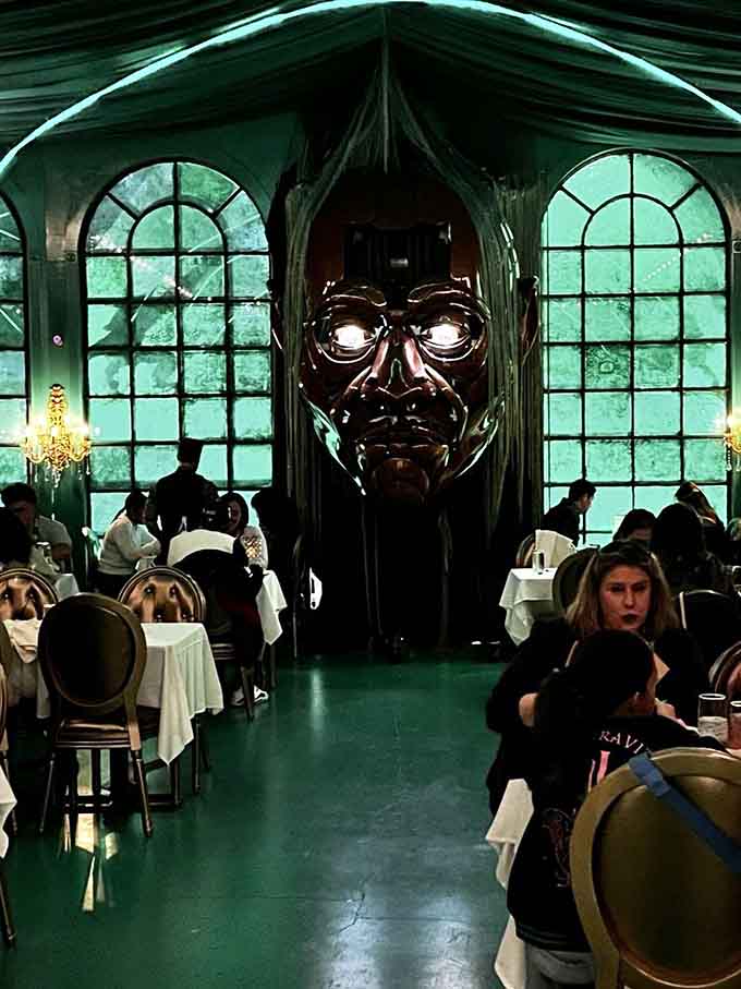 That enormous bronze mask watches over diners with an expression somewhere between mysterious and mildly amused by everything.