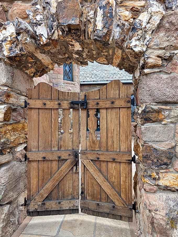 That weathered wooden gate set in ancient stone isn't just an entrance, it's a portal to another era entirely.