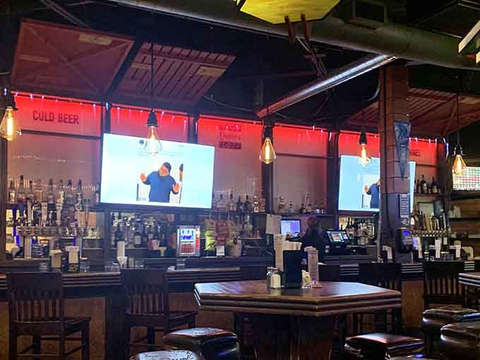 The bar area beckons with cold drinks and big screens, perfect for enjoying a slice while catching the game.