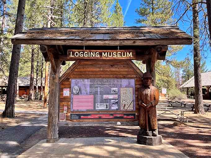 A carved logger stands guard, welcoming visitors to discover the frontier days of Oregon timber.