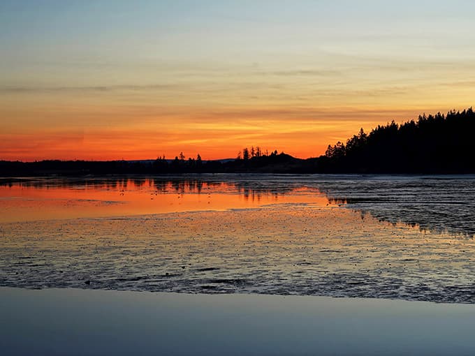 Sunsets paint the bay in colors that remind you why coastal living beats city life every blessed evening.