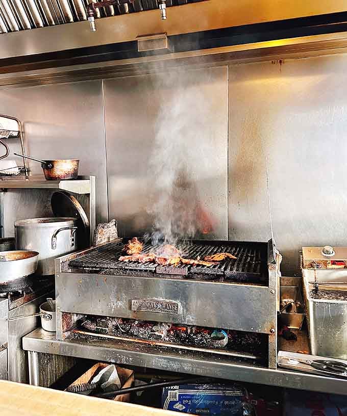 Flames and smoke rising from the grill like a delicious signal fire calling all hungry souls to gather.