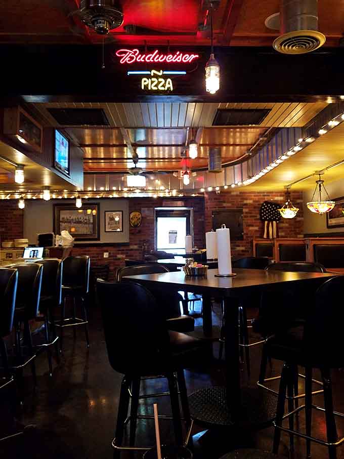 Neon signs and booth seating create that classic pizzeria atmosphere where memories and appetites are equally satisfied.