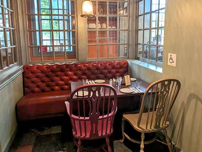 A cozy tufted leather booth by the windows offers the perfect spot for intimate conversations or solo dining without feeling like you're on display.