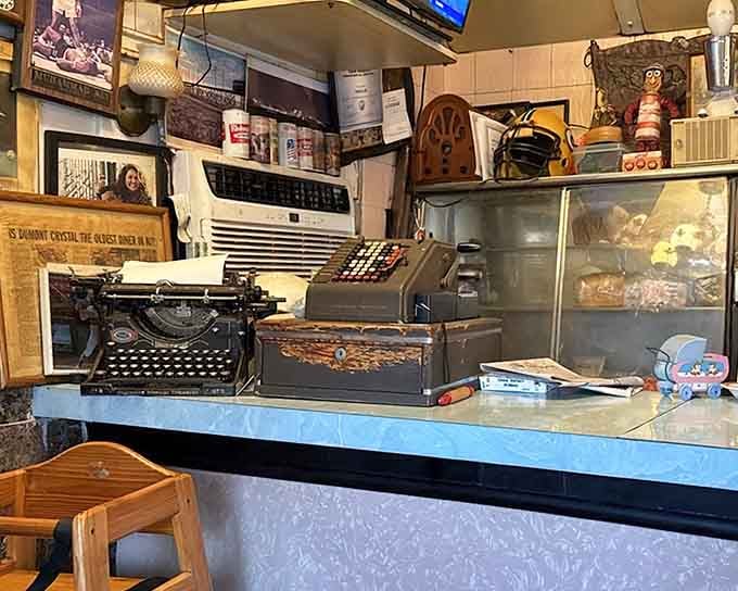 A vintage typewriter and old cash register sit among the clutter, reminding you that this place has stories older than most restaurants' lifespans.