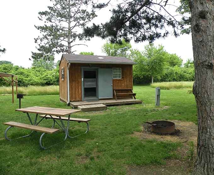 Cozy cabin living with a picnic table and fire ring, everything you need for s'mores and stargazing.