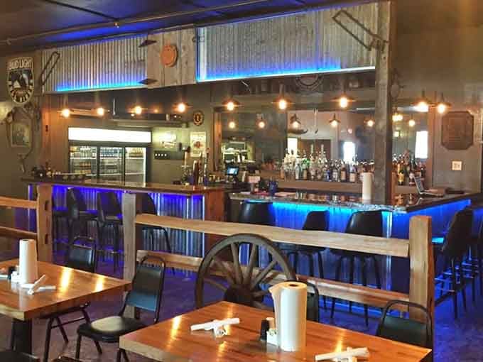The bar area glows with blue lights and possibilities, perfect for unwinding after a long week.