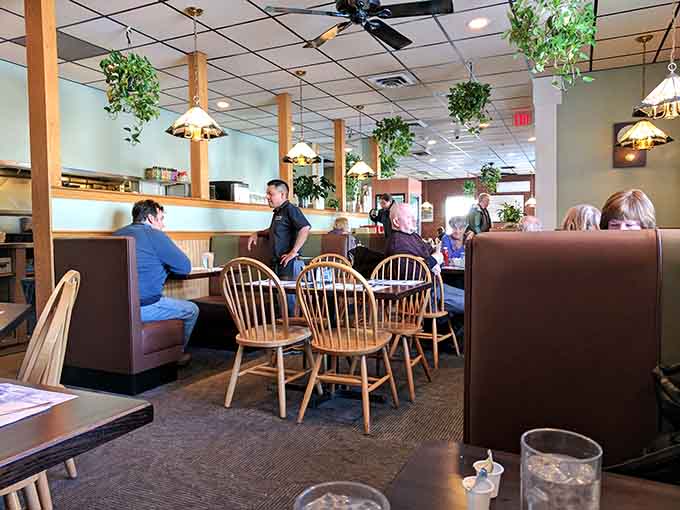 Real people enjoying real meals in comfortable booths, the kind of scene Norman Rockwell would paint if he loved diners.
