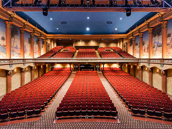 From the balcony, palm trees and pyramids painted on walls create an outdoor courtyard illusion.