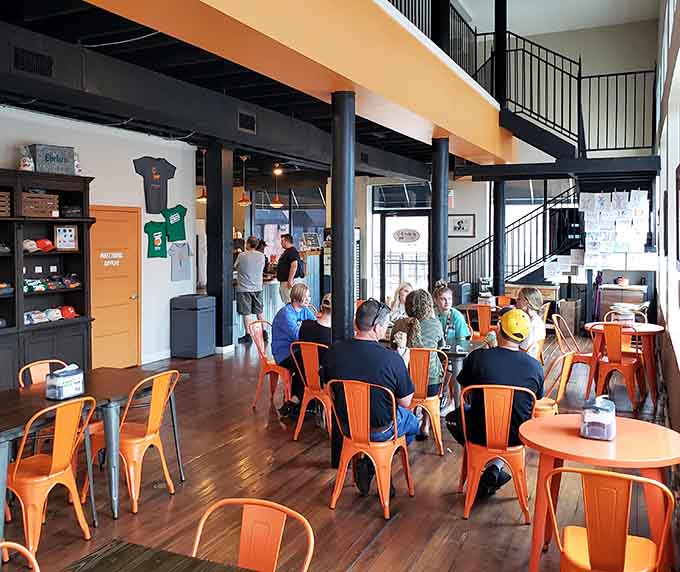 Orange chairs fill with happy customers enjoying their treats, creating a scene that perfectly captures the communal joy of good ice cream.