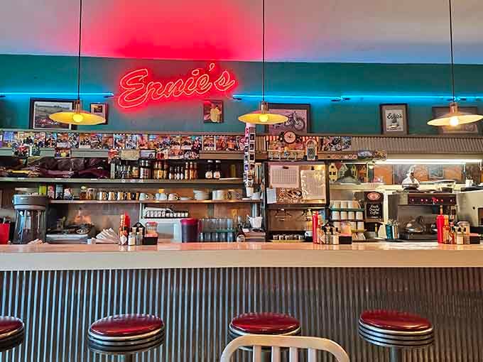 The counter with its glowing neon sign offers front-row seats to breakfast magic happening right before your eyes.