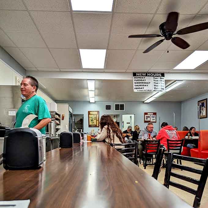 The lunch counter buzzes with conversation as locals and visitors alike gather for their green chile fix and friendly company.
