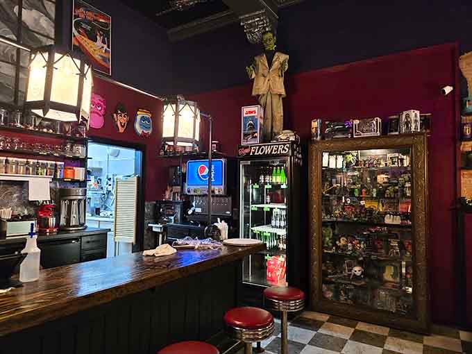Behind the counter, vintage collectibles and classic diner stools create an atmosphere that's pure Americana meets Universal Studios.