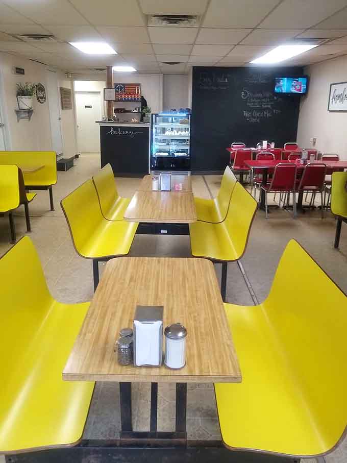 Clean, comfortable dining space with cheerful yellow seating invites you to sit, relax, and enjoy your homestyle meal.