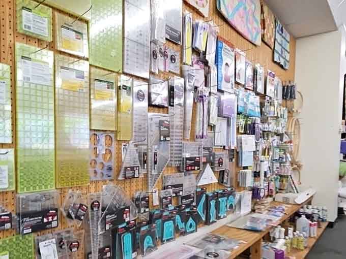A sewing supply wall that looks like someone organized every notion you've ever needed and several you didn't know existed.