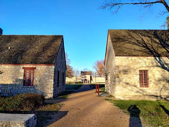 Stone buildings flank the pathway leading deeper into the fort, their weathered walls telling stories spanning centuries of history.