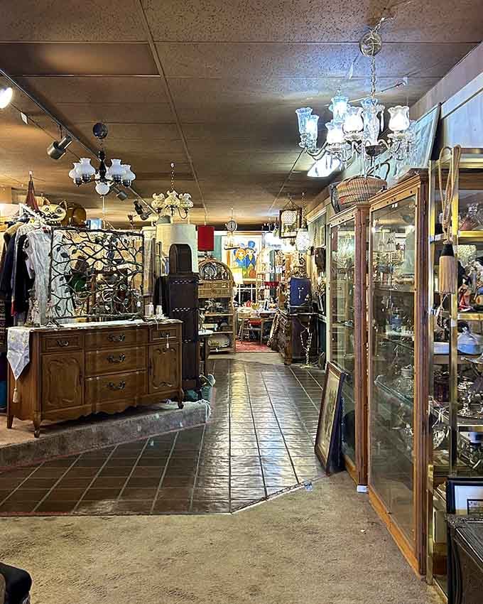 Chandeliers dangle overhead like crystal guardians watching over decades of accumulated memories and forgotten treasures below.