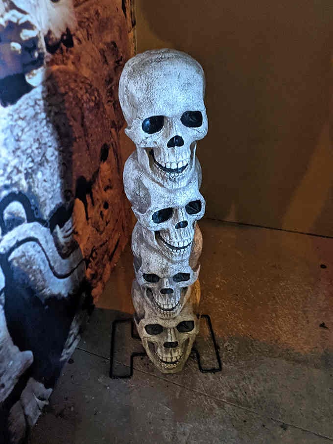 Four skulls stacked up like the world's creepiest game of Jenga, just casually waiting to greet you inside.