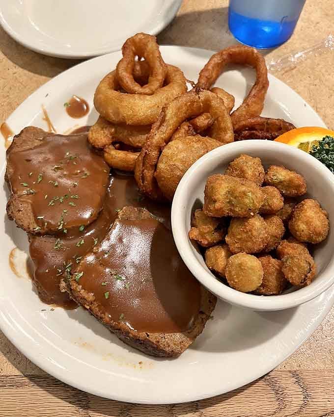 Homemade meatloaf with onion rings and fried okra creates a comfort food trifecta that would make any grandmother nod with approval.