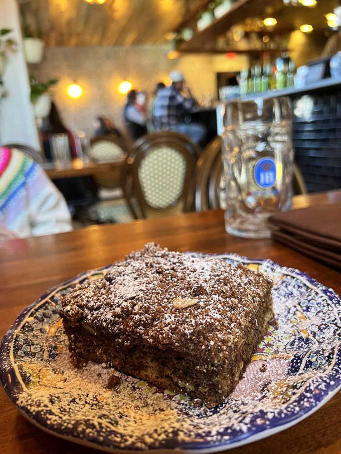 Coffee cake dusted with powdered sugar, sitting pretty on vintage china like it's posing for its close-up.