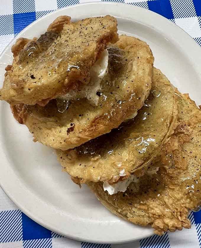 Fried green tomatoes glistening with that perfect golden crust, proving vegetables can be absolutely irresistible when properly prepared.
