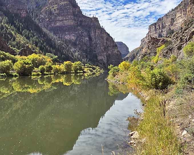 The Colorado River reflects the canyon walls like a mirror made specifically for Instagram.