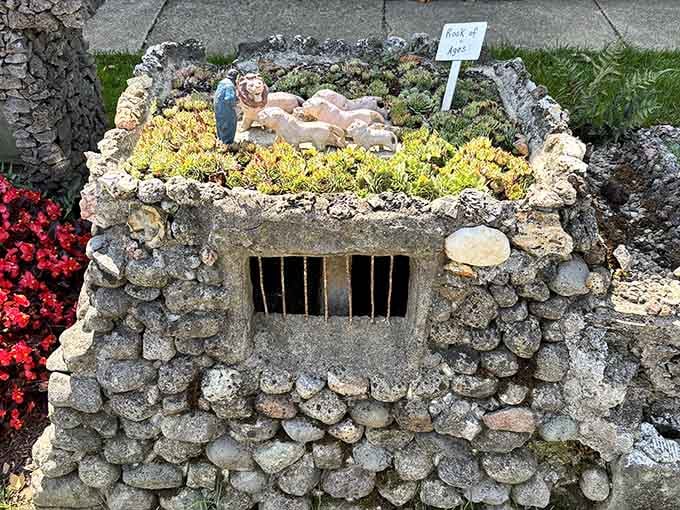 The Rock of Ages display features figurines nestled in moss, blending spiritual reverence with the garden's playful artistic spirit beautifully.