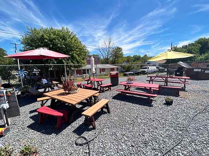 Colorful umbrellas shade the outdoor seating area where gravel meets good times and even better smoked meat.
