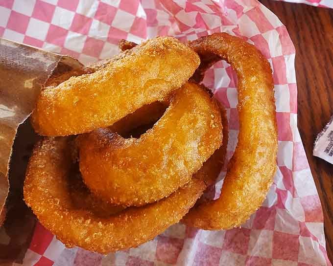 Onion rings so perfectly golden and crispy, they could make a grown person reconsider their entire relationship with vegetables.