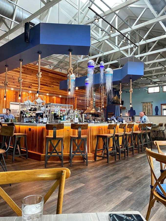 The bar glows like a beacon of hospitality, complete with jellyfish lights that add whimsy to your drinking experience.