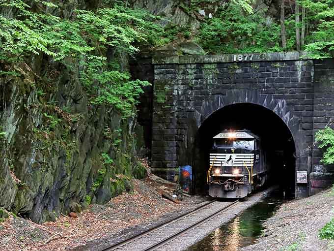 When a freight train emerges from darkness, you're watching living history that connects past tragedy to present commerce.
