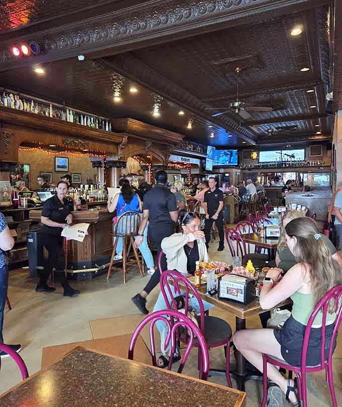 Busy lunch service with happy diners and attentive staff, the kind of scene that makes restaurants feel truly alive.